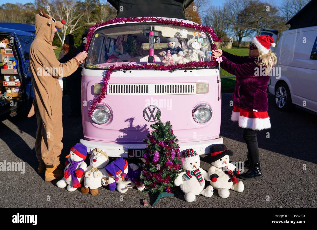 Participants place Christmas decorations on their VW camper van during ...