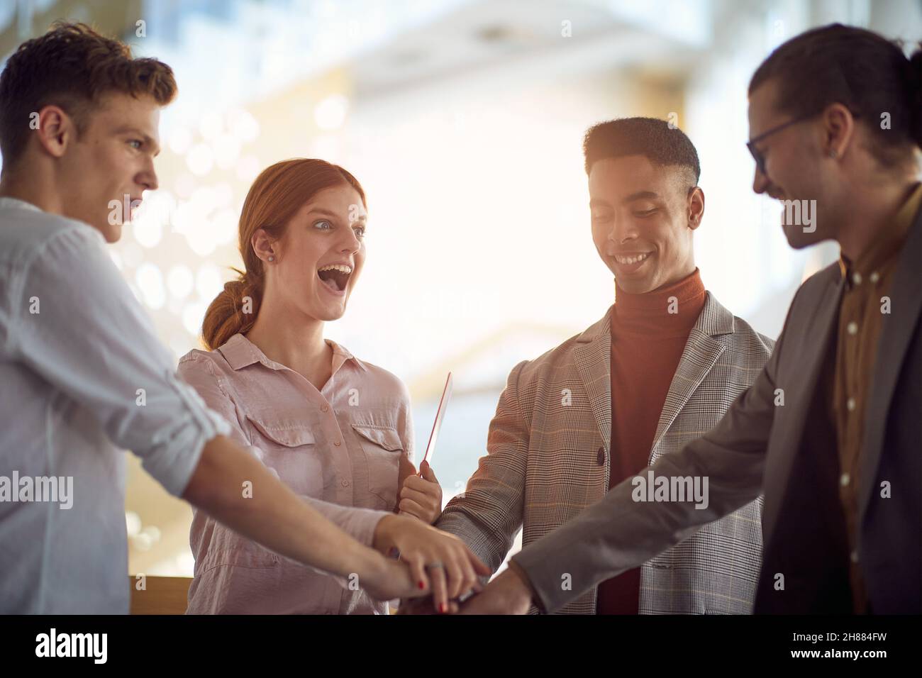 A group of young business people having a good time in a friendly ...