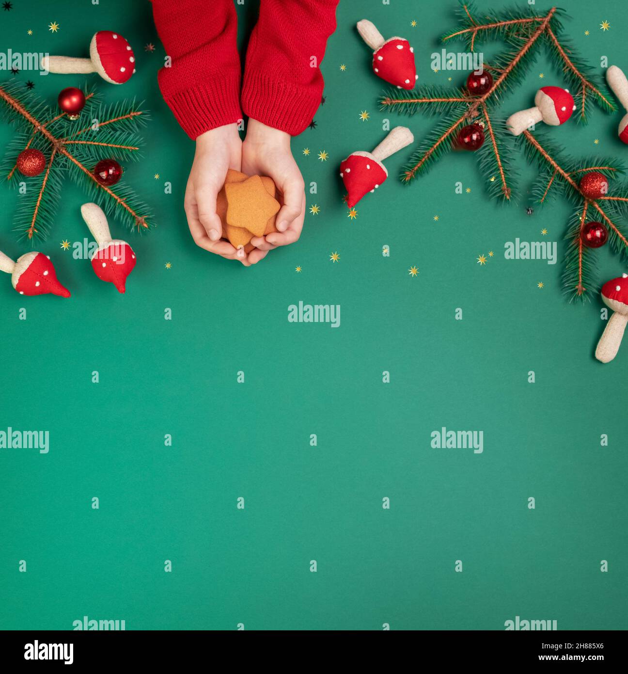 Gingerbread in the hands of a child on a green background with ...