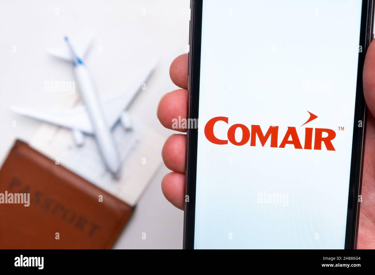 Comair Airlines app logo on the screen of mobile phone. A blurry image ...