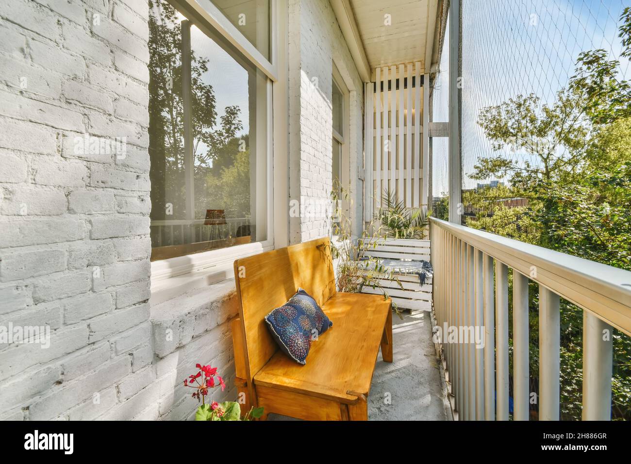 Cozy nice balcony with a yellow bench Stock Photo - Alamy