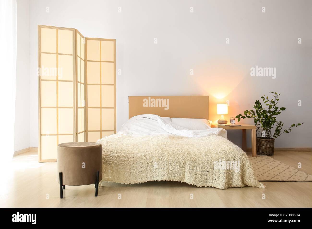 Stylish folding screen in bedroom interior Stock Photo - Alamy