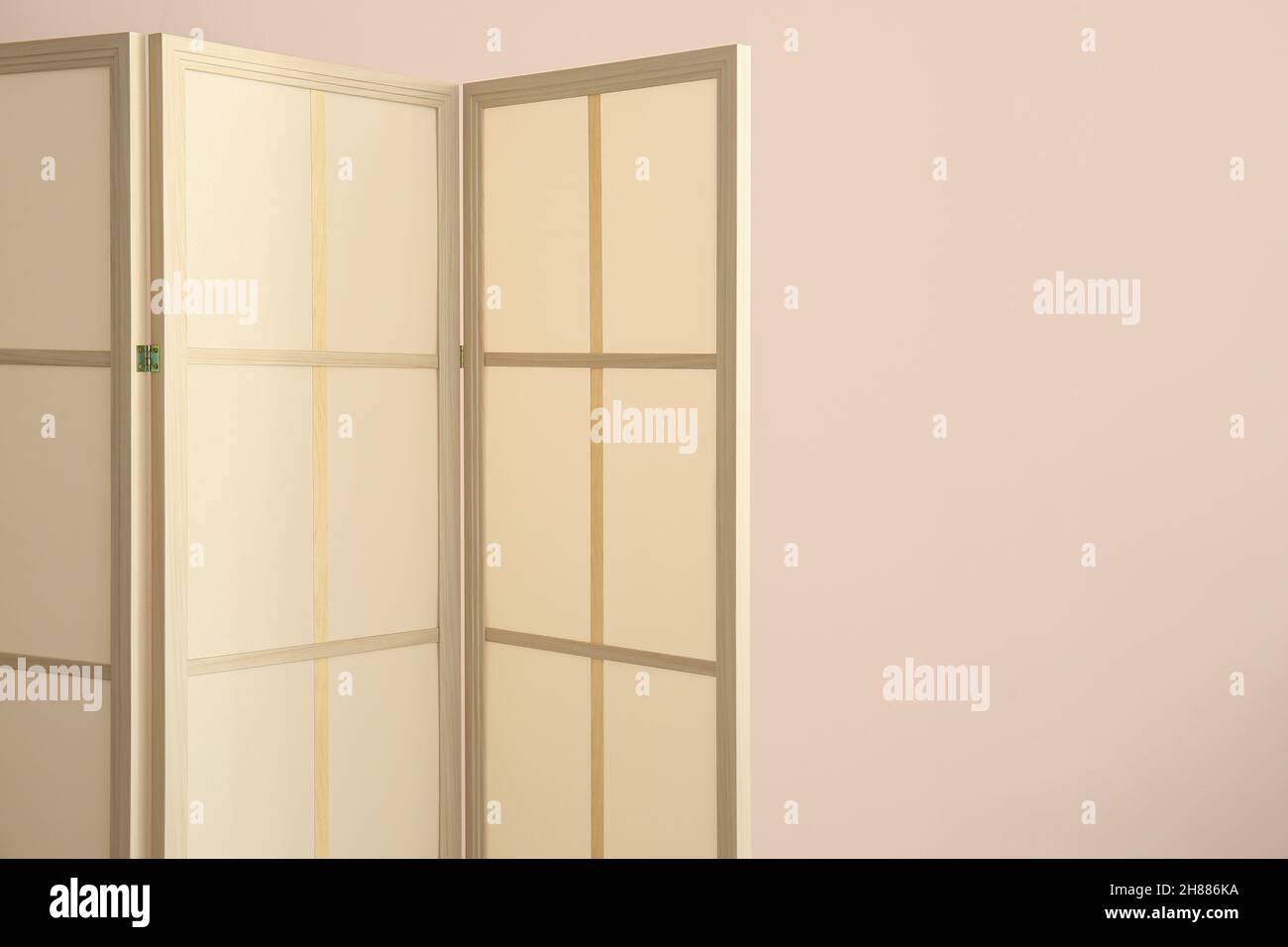 Stylish folding screen near wall in room Stock Photo - Alamy