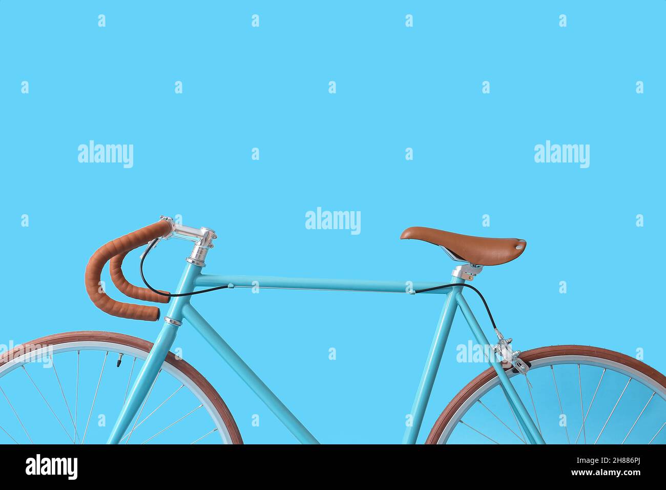 Modern bicycle on blue background Stock Photo - Alamy