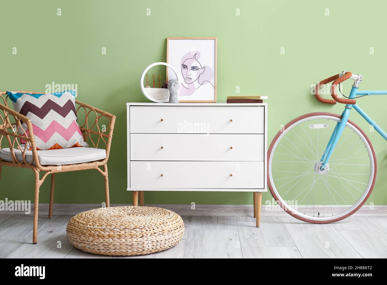 Interior of stylish room with chair, chest of drawers and bicycle Stock ...