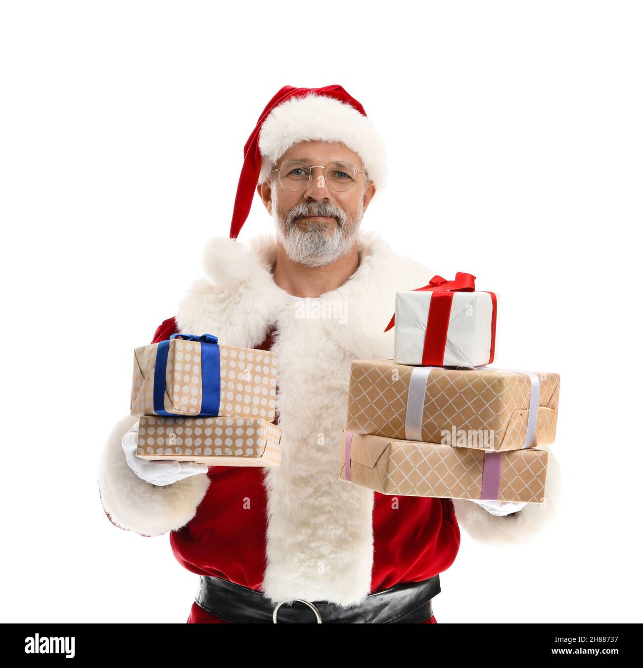 Santa Claus holding stacks of Christmas presents on white background ...