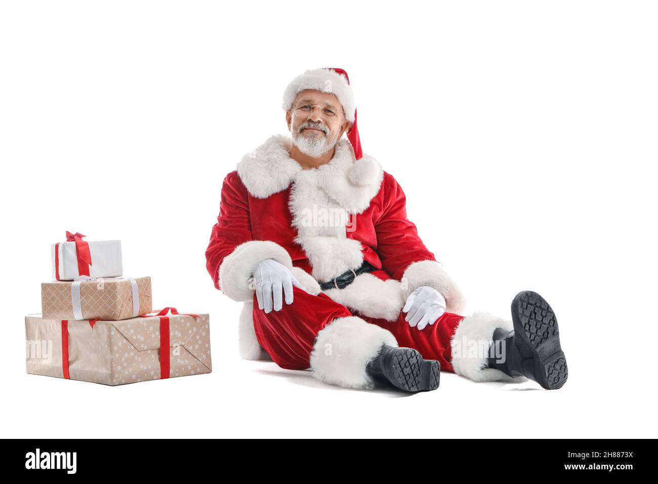 Santa Claus and stack of Christmas presents on white background Stock ...