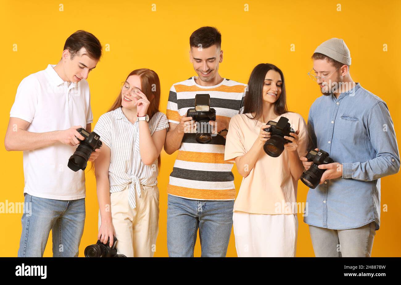 Group of photographers on color background Stock Photo - Alamy