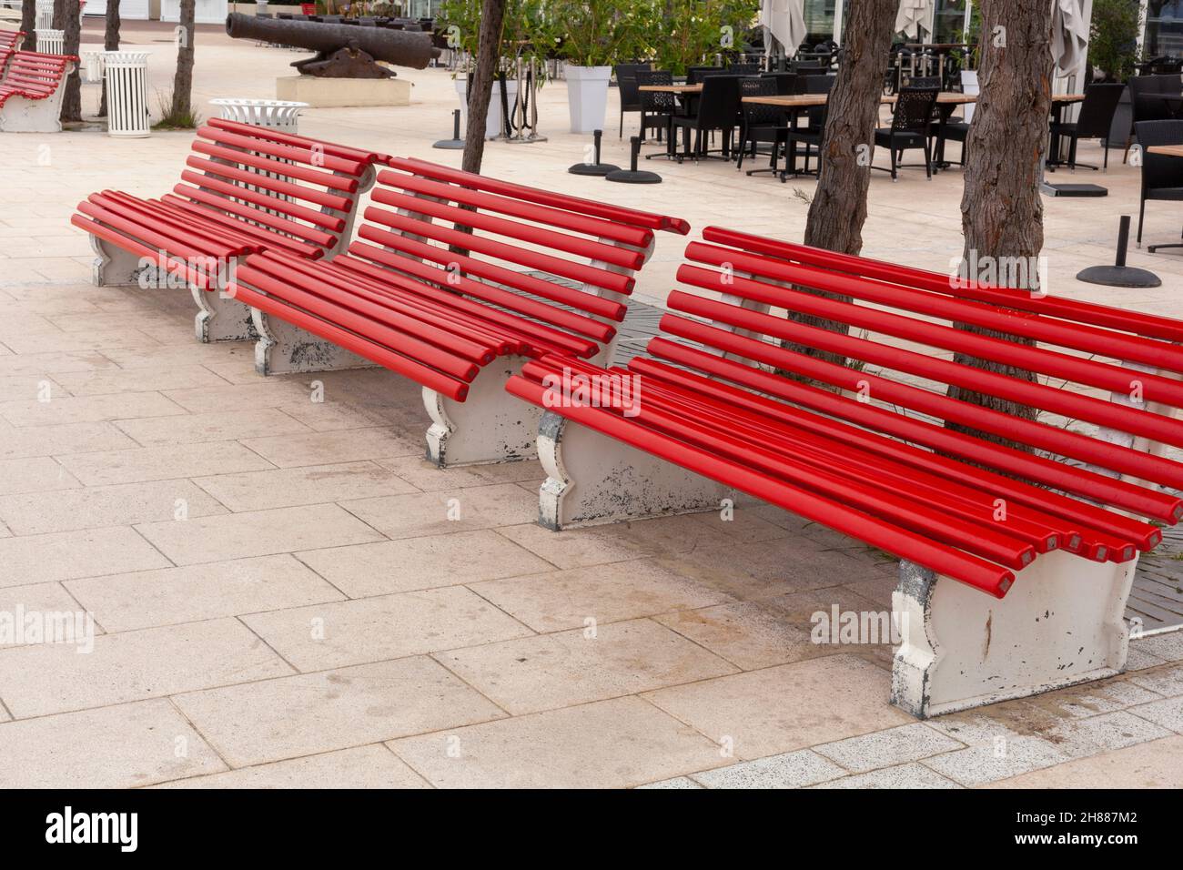 Wooden red benches on a city street Stock Photo - Alamy