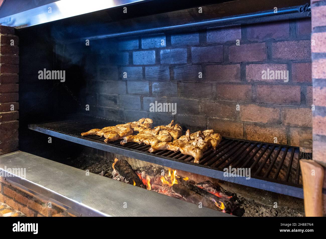 A fresh chickens are getting cooked on the grill Stock Photo - Alamy