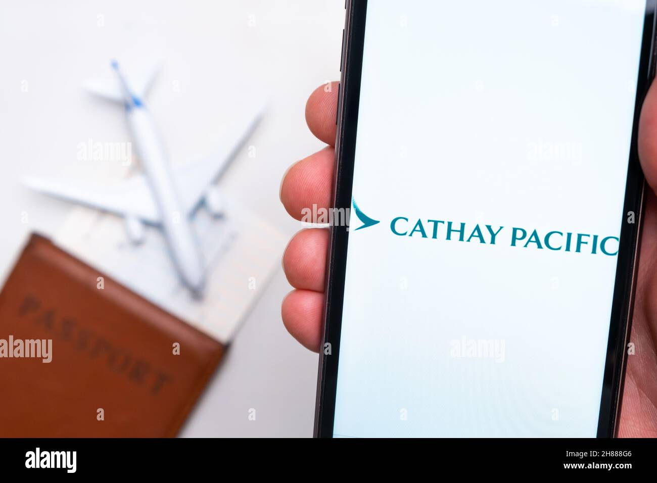 Cathay pacific Airlines app logo on the screen of mobile phone. A ...