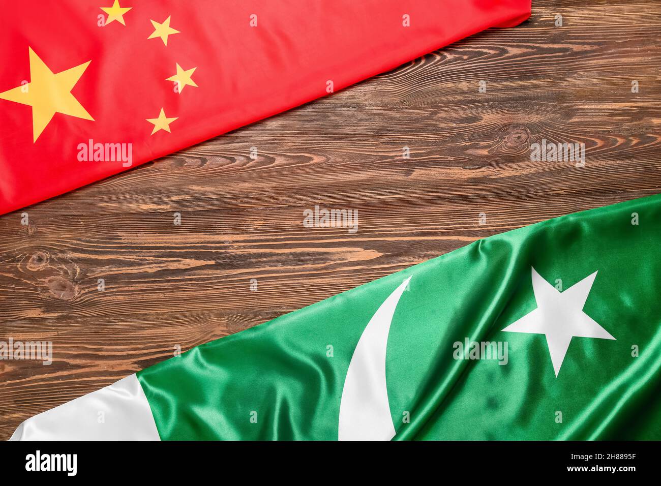 Flags of China and Pakistan on wooden background Stock Photo - Alamy