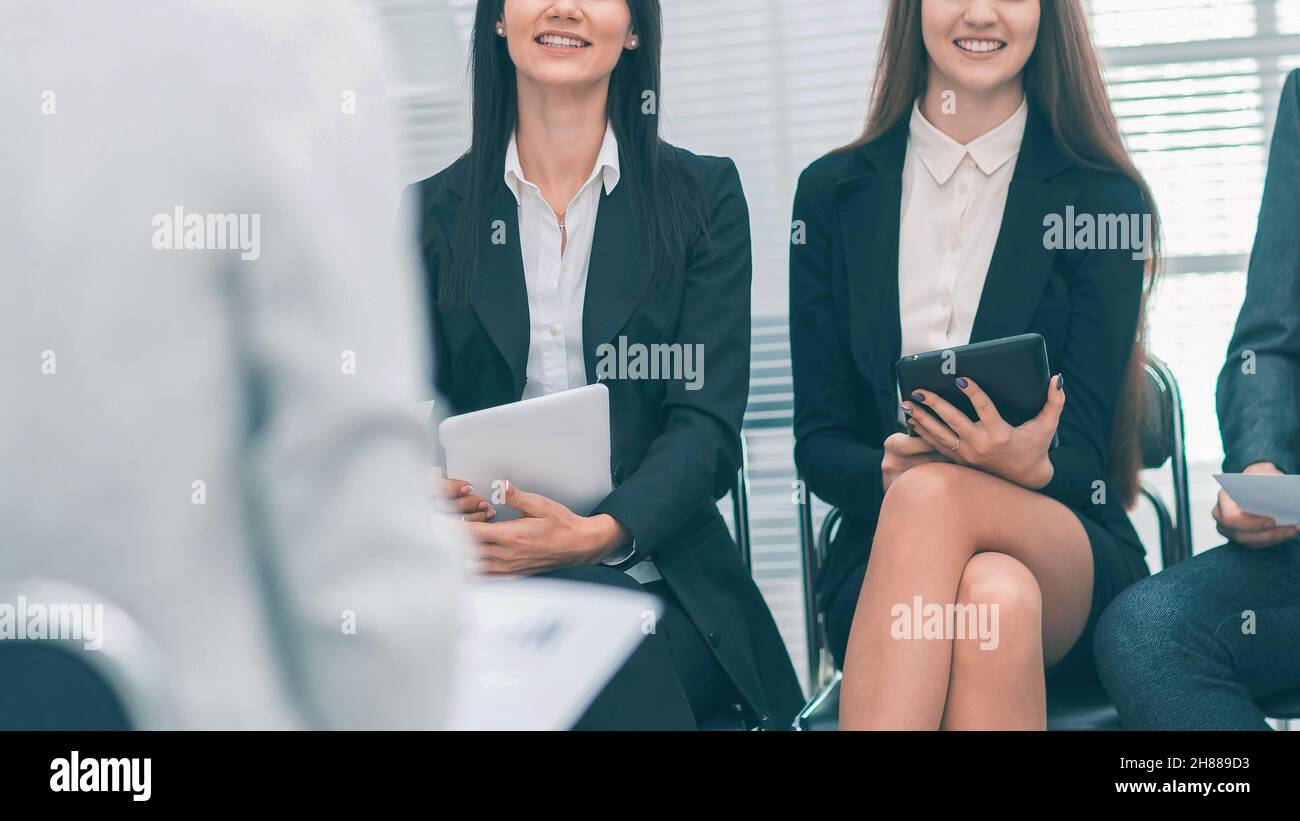 close up. employees asking questions at a work meeting Stock Photo - Alamy