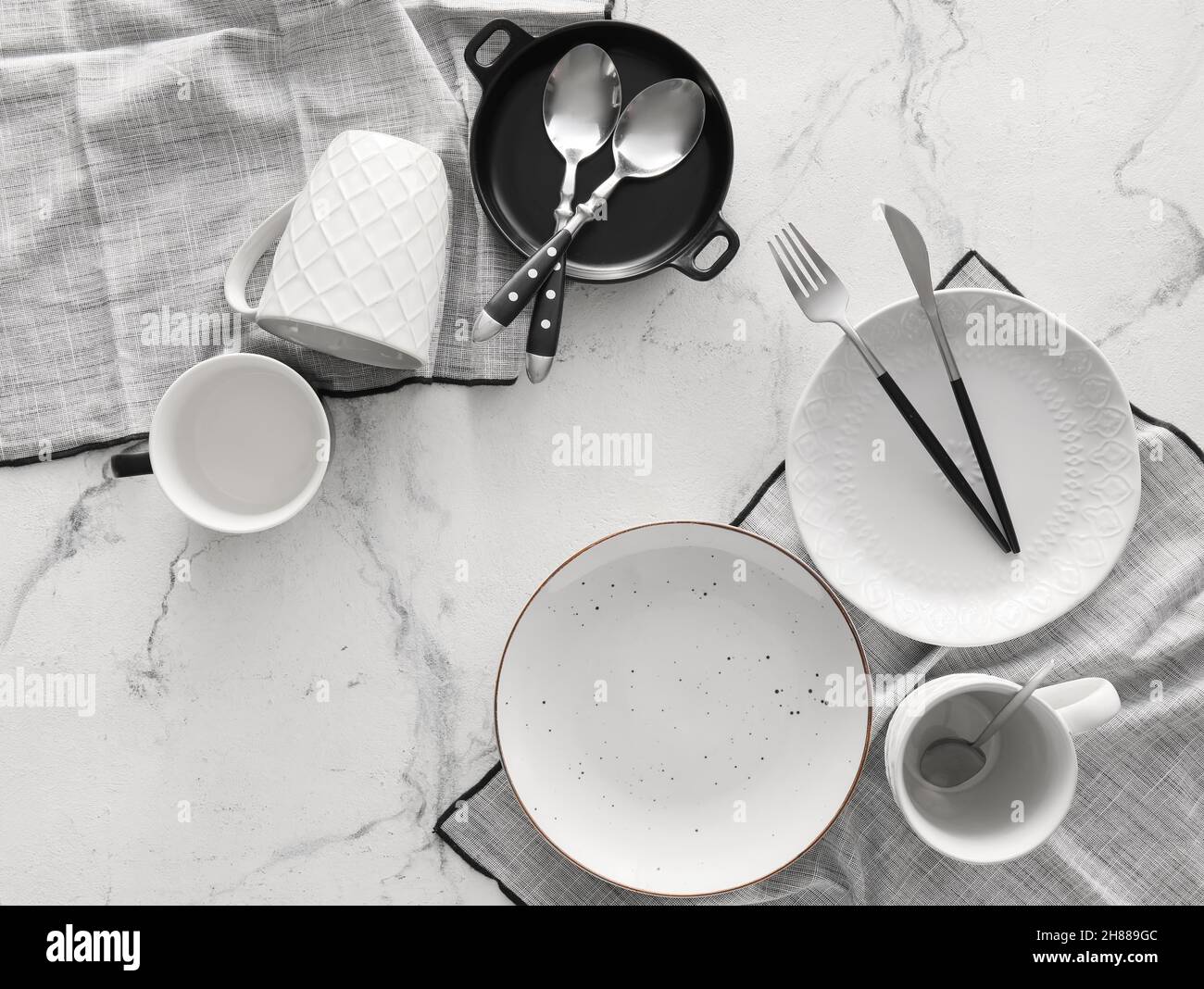 Set of stylish dinnerware on light background Stock Photo - Alamy
