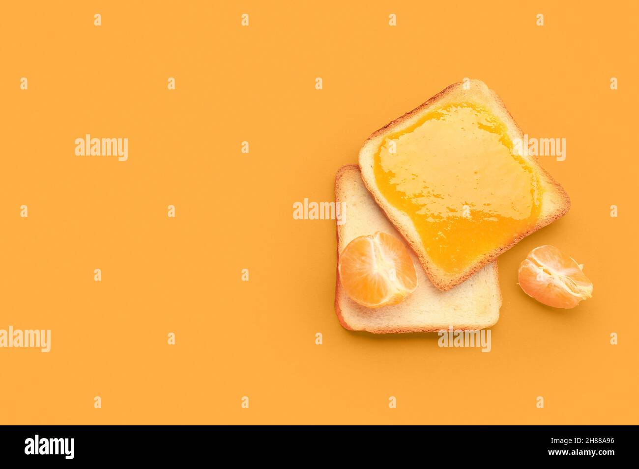 Tasty toast with tangerine jam on orange background Stock Photo - Alamy