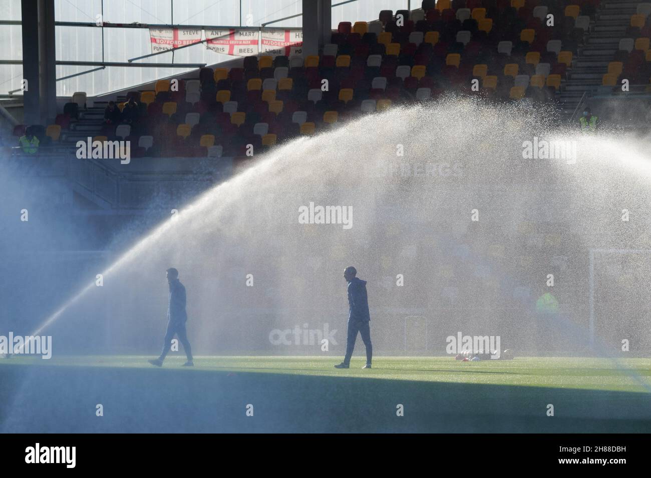 Sprinklers in action on a cloud and sunny day at Brentford Stadium ...