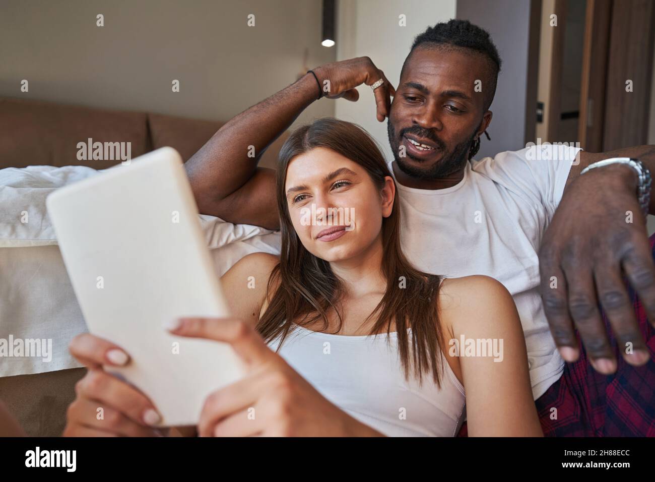 Concentrated female and man watching something on gadget Stock Photo ...