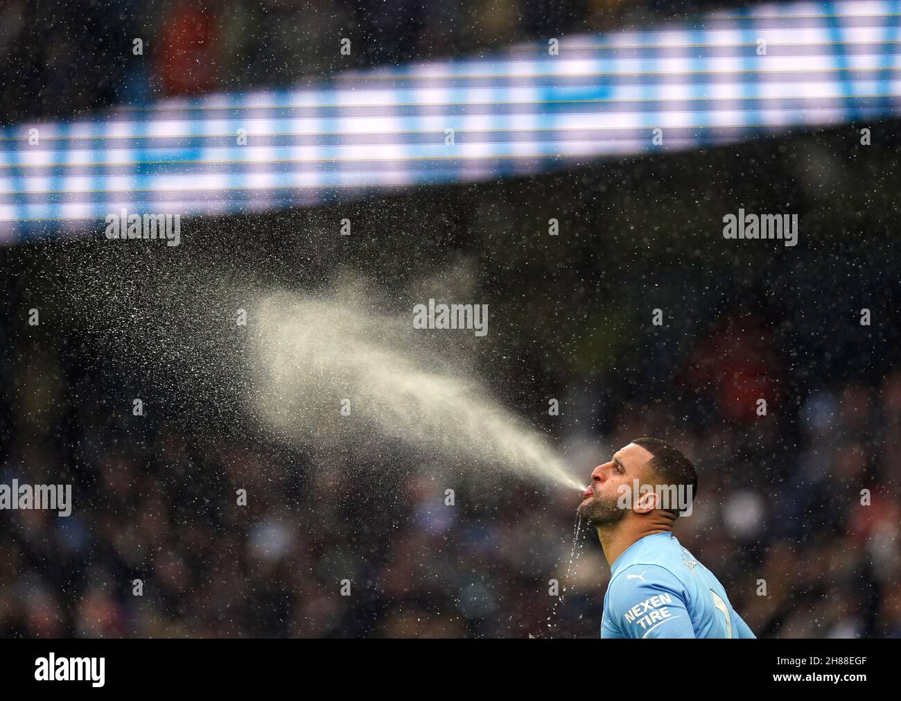 Manchester City's Kyle Walker spits out water before the Premier League ...