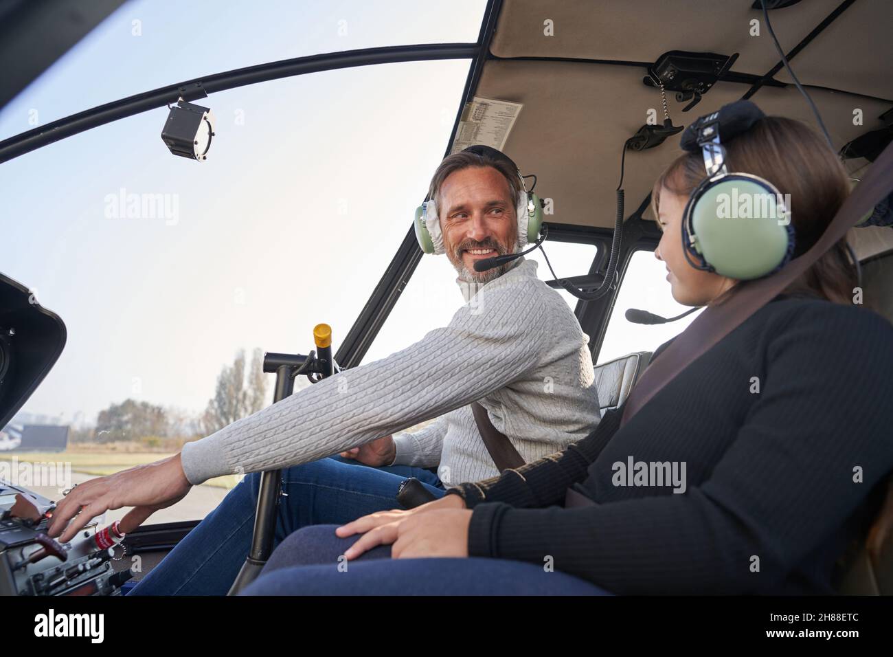 Cheerful father going on a helicopter flight with his child Stock Photo ...