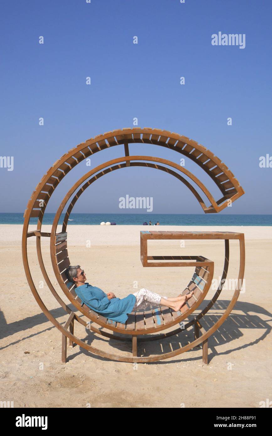 European woman relaxing on the beach, Bilaj Al Jazayer Beach, Kingdom ...