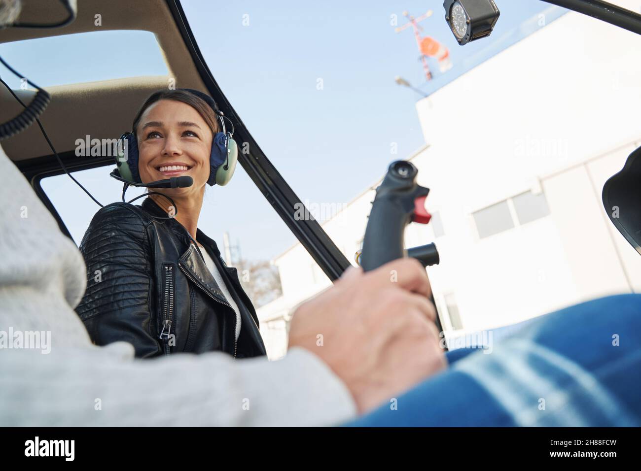 Thrilled young woman having fun on a helicopter ride Stock Photo - Alamy