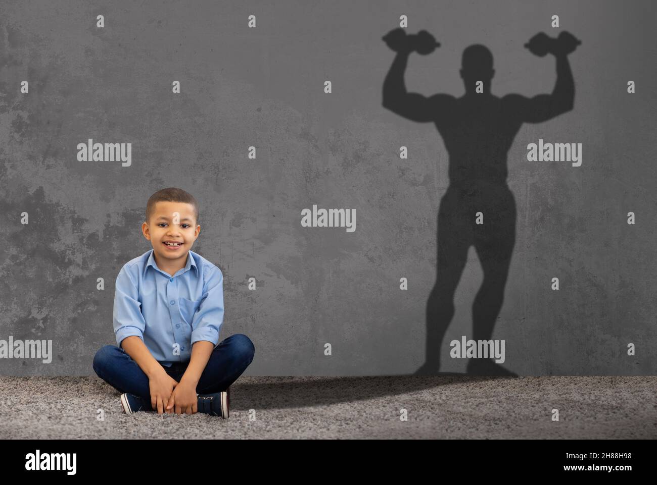 Black boy and drawn shadow of male bodybuilder behind him Stock Photo ...