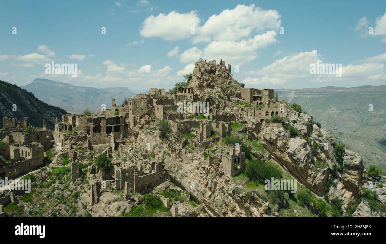 Ancient stone city on rock on background of mountains. Action. Amazing ...