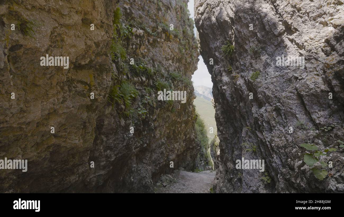 Narrow passage in rocks. Action. Dangerous narrow gorge between two ...