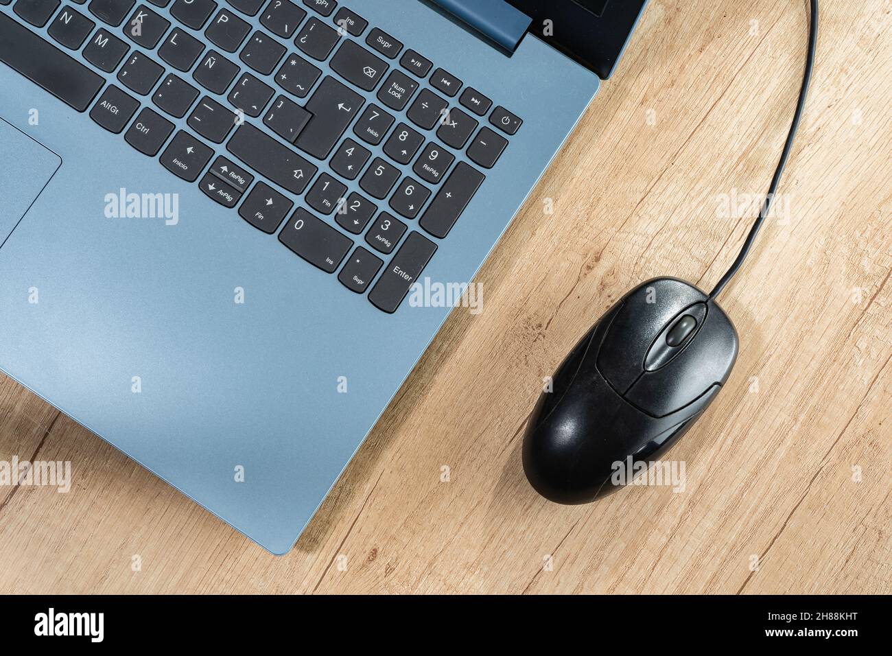 A Keyboard of a laptop and a mouse on a table. Technology ...