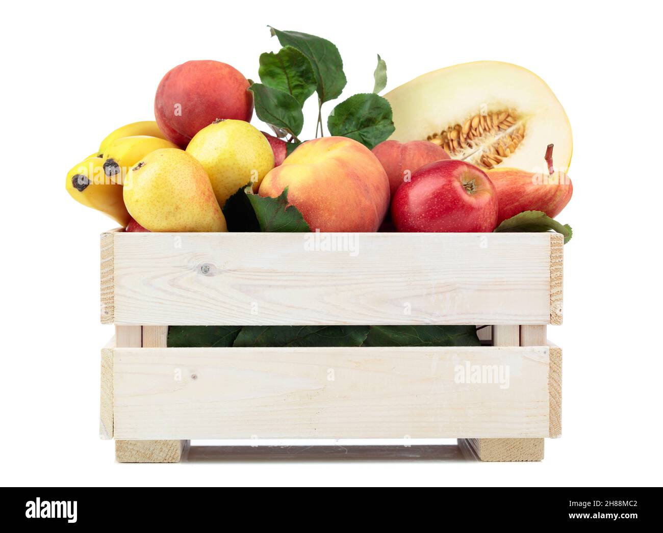 Fresh fruits in a wooden box isolated on a white background. Apples ...