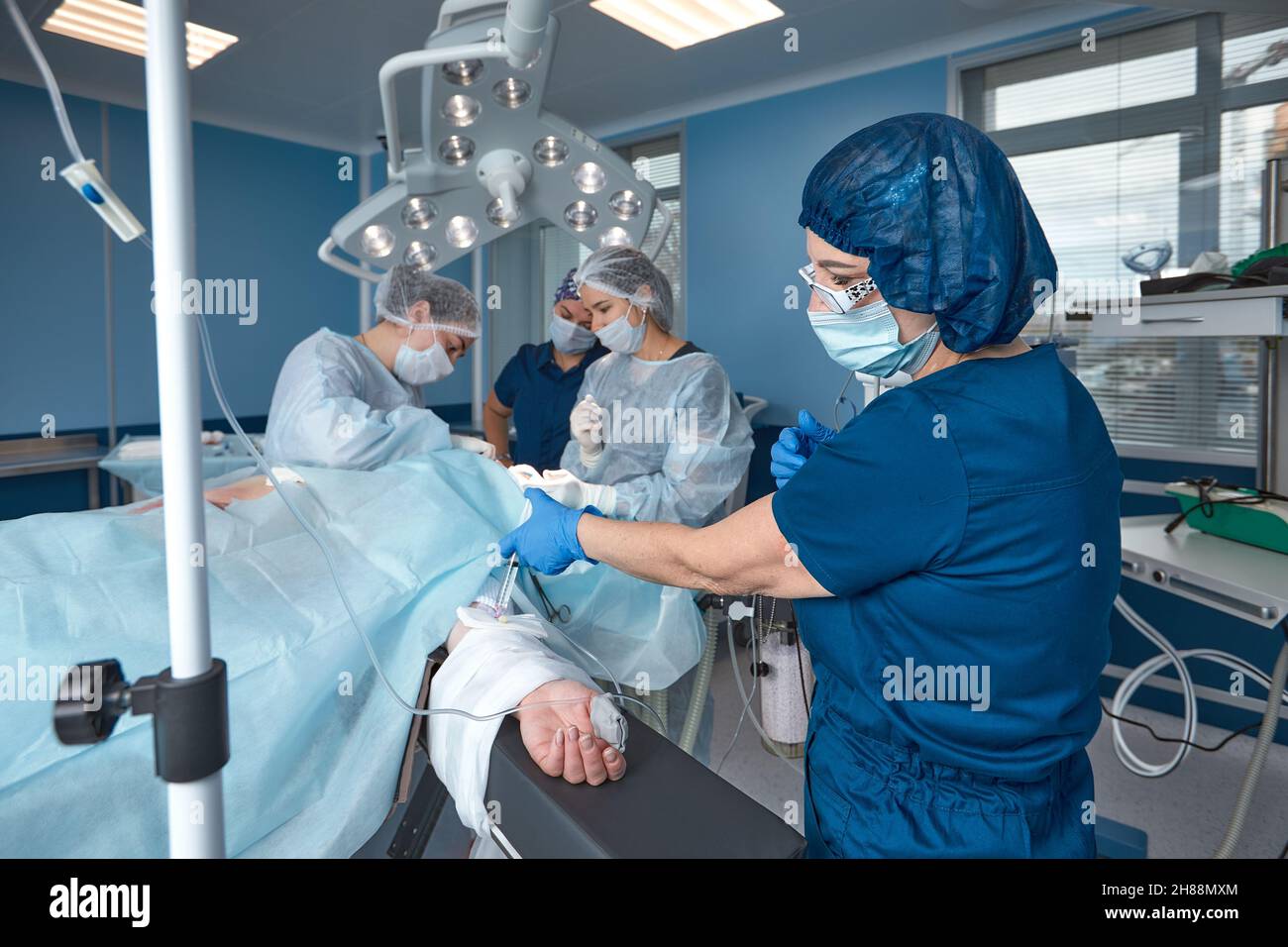 Concentrated Surgical team operating a patient in an operation theater ...