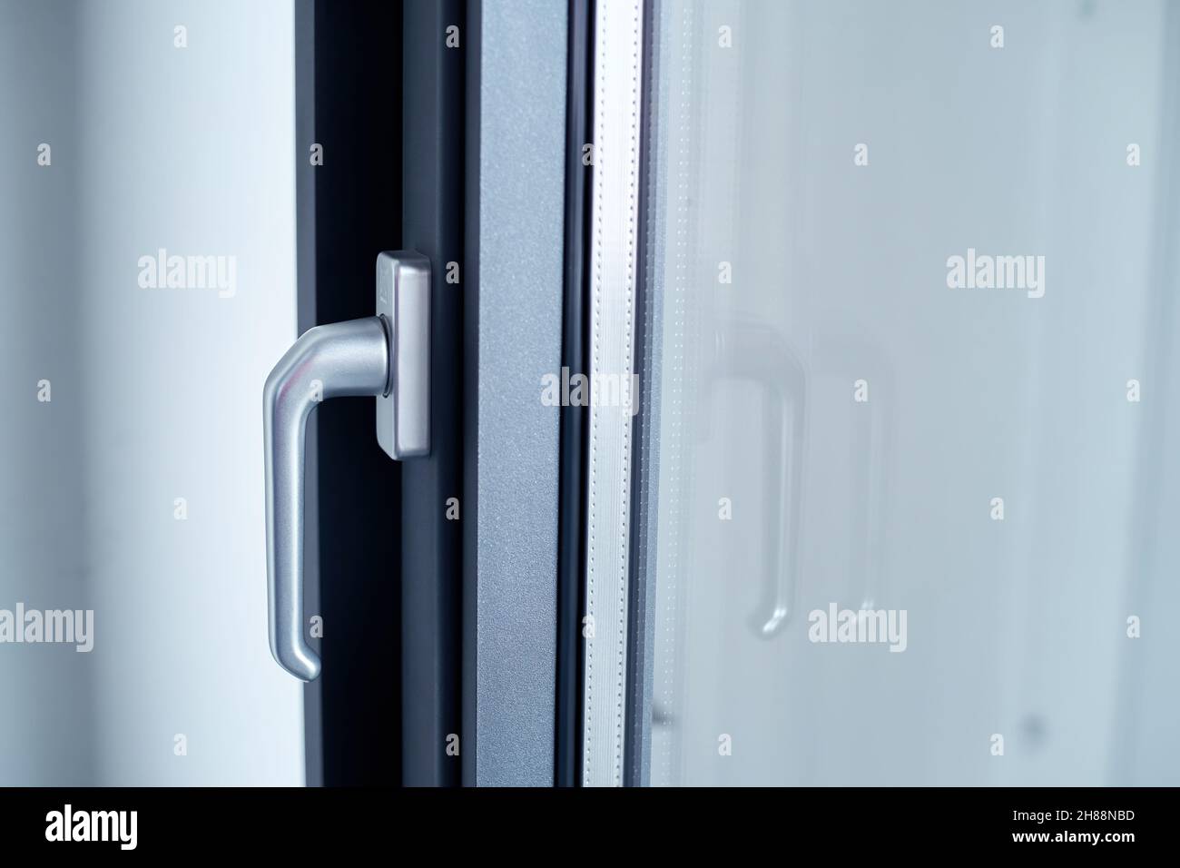 stylish chrome handle on a dark window frame Stock Photo - Alamy