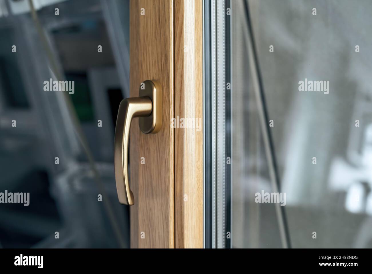 stylish handle on the window frame in gold color Stock Photo - Alamy