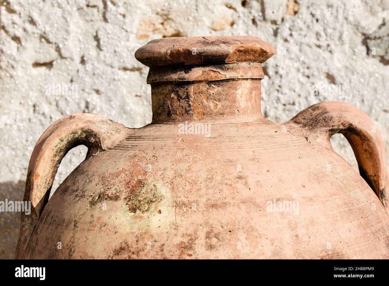 Detail of an old Terracotta Amphora with two handles, in the small ...