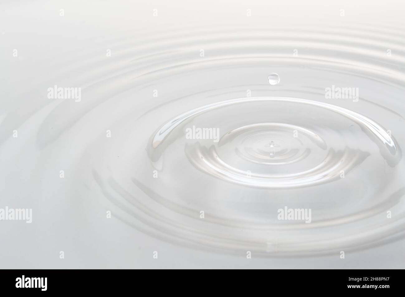 Water drop falling into water making a perfect droplet splash Stock ...