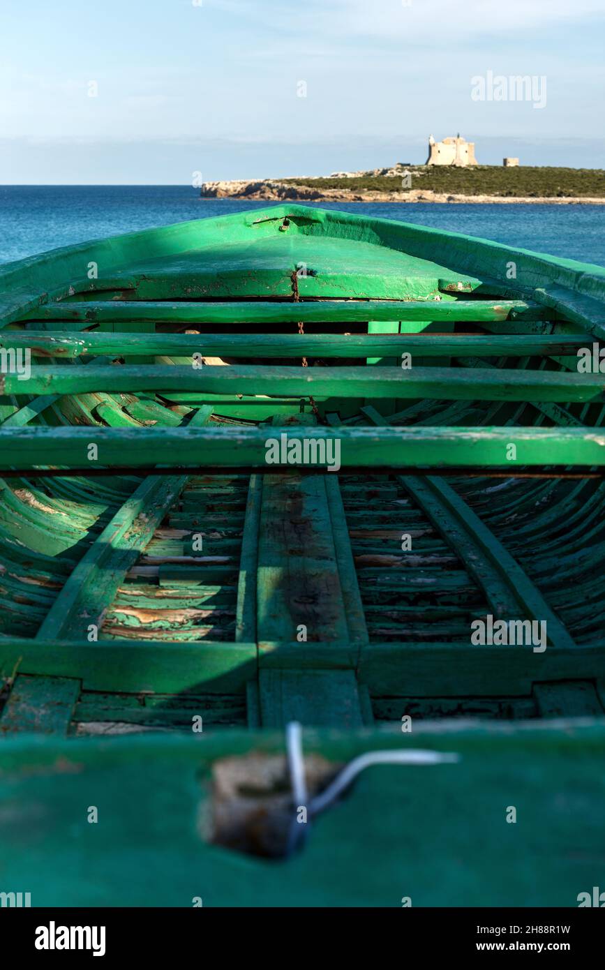 The Capo Passero Island (Cape Passero) with a boat of migrants ...