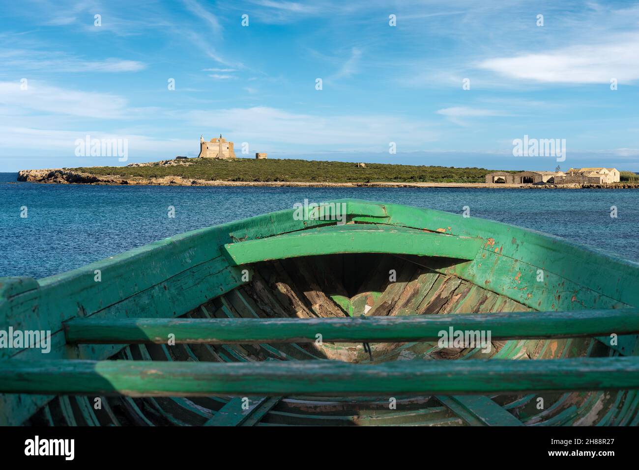 The Capo Passero Island (Cape Passero) with a boat of migrants ...