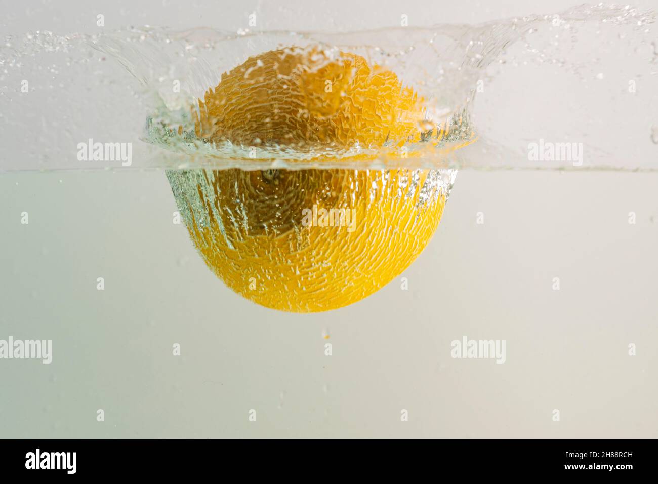 Beautiful view of melon falling into water on turquoise background ...