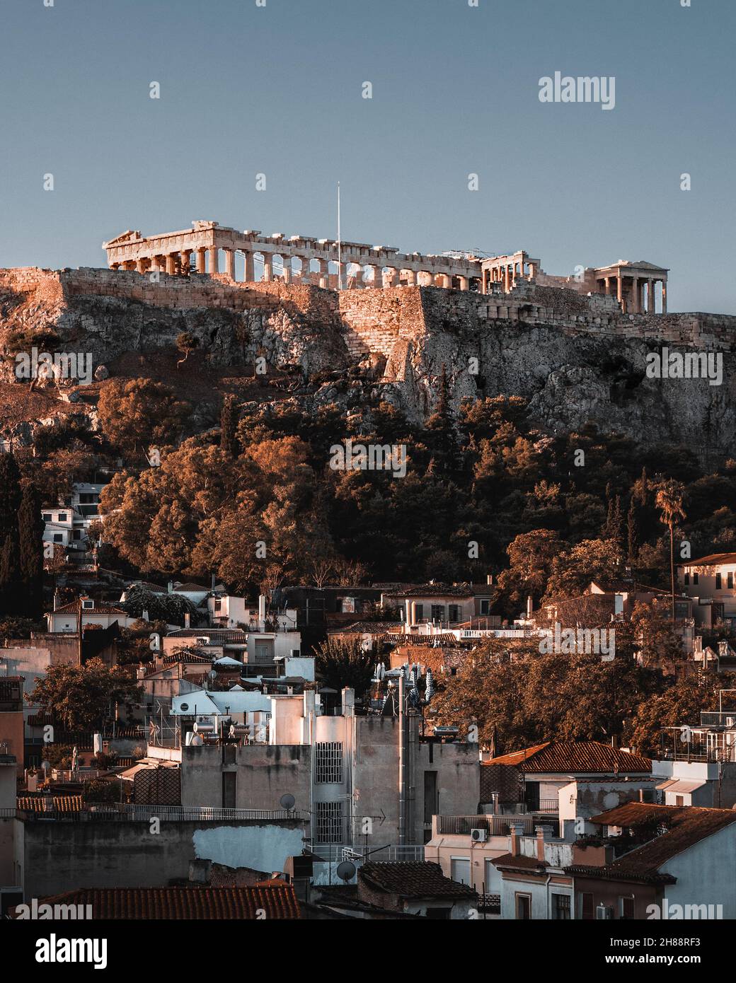 A beautiful sunset over The Parthenon and The Acropolis of Athens atop ...