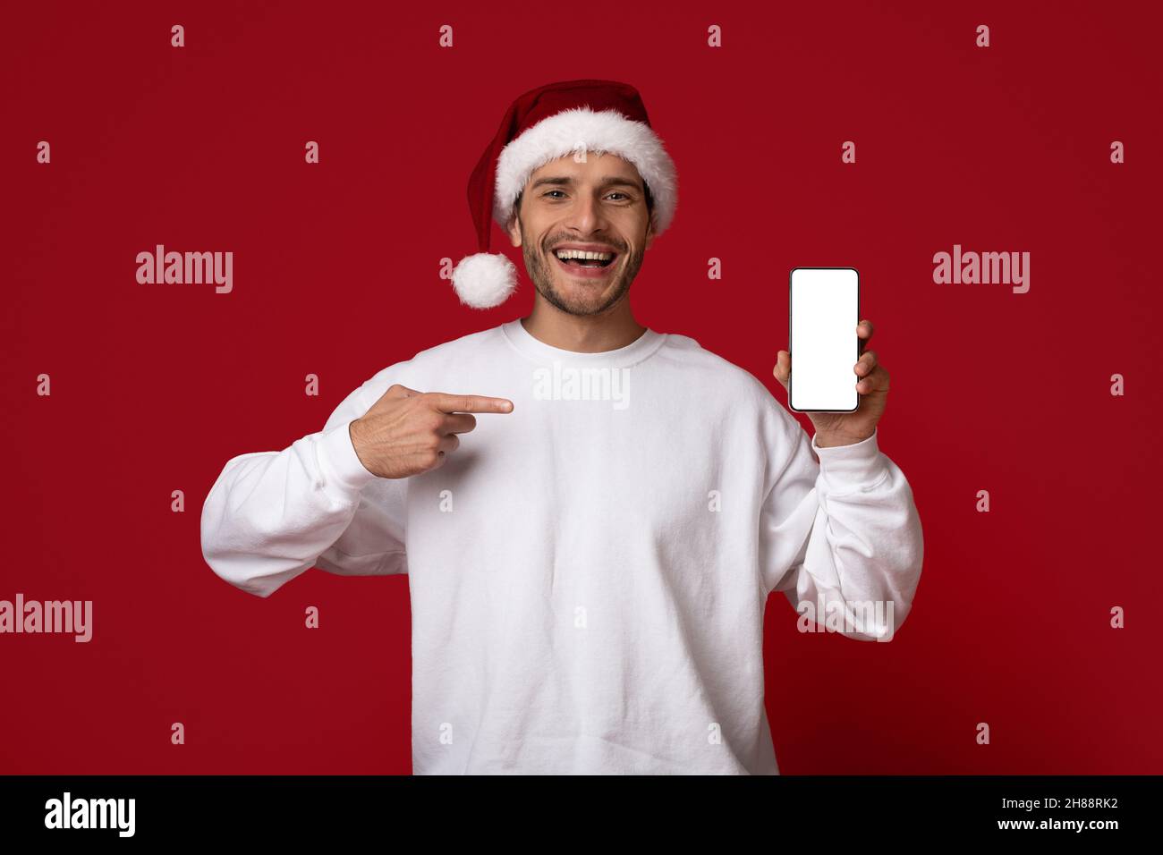 Great App. Cheerful Man In Santa Hat Pointing At Blank Smartphone ...