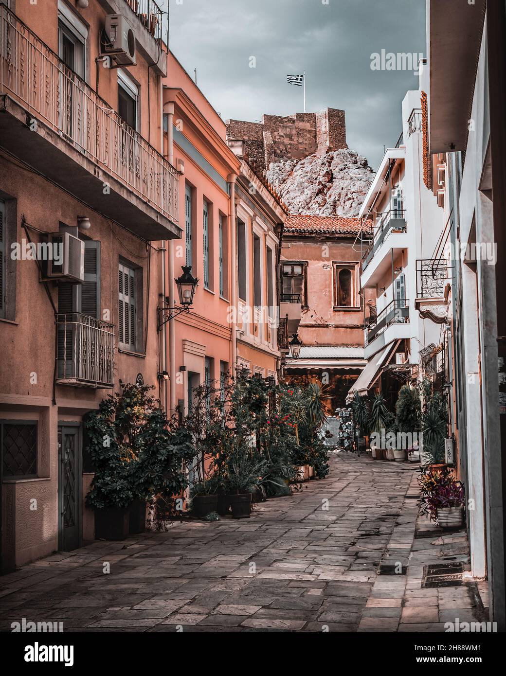 A view of the Acropolis of Athens from a moody street in the heart of ...