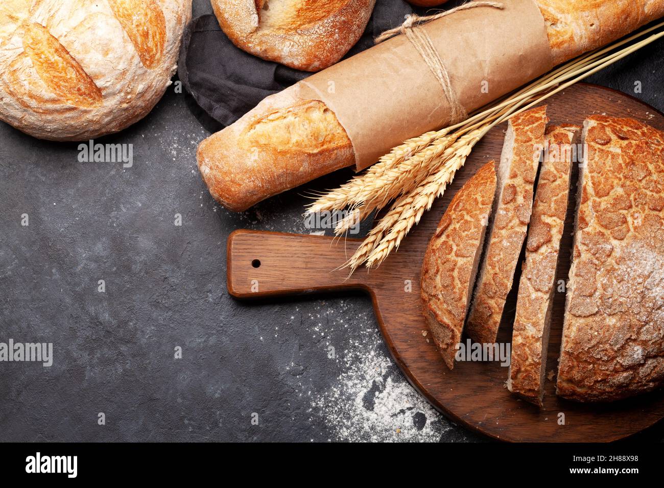 Various types of bread on stone table. With copy space Stock Photo - Alamy