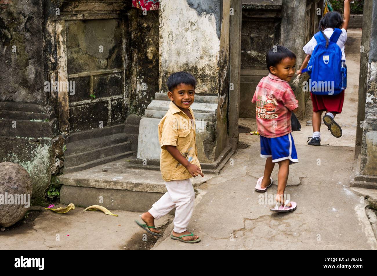 Smiling and happy Asian pupil kids going home. One girl wearing her ...