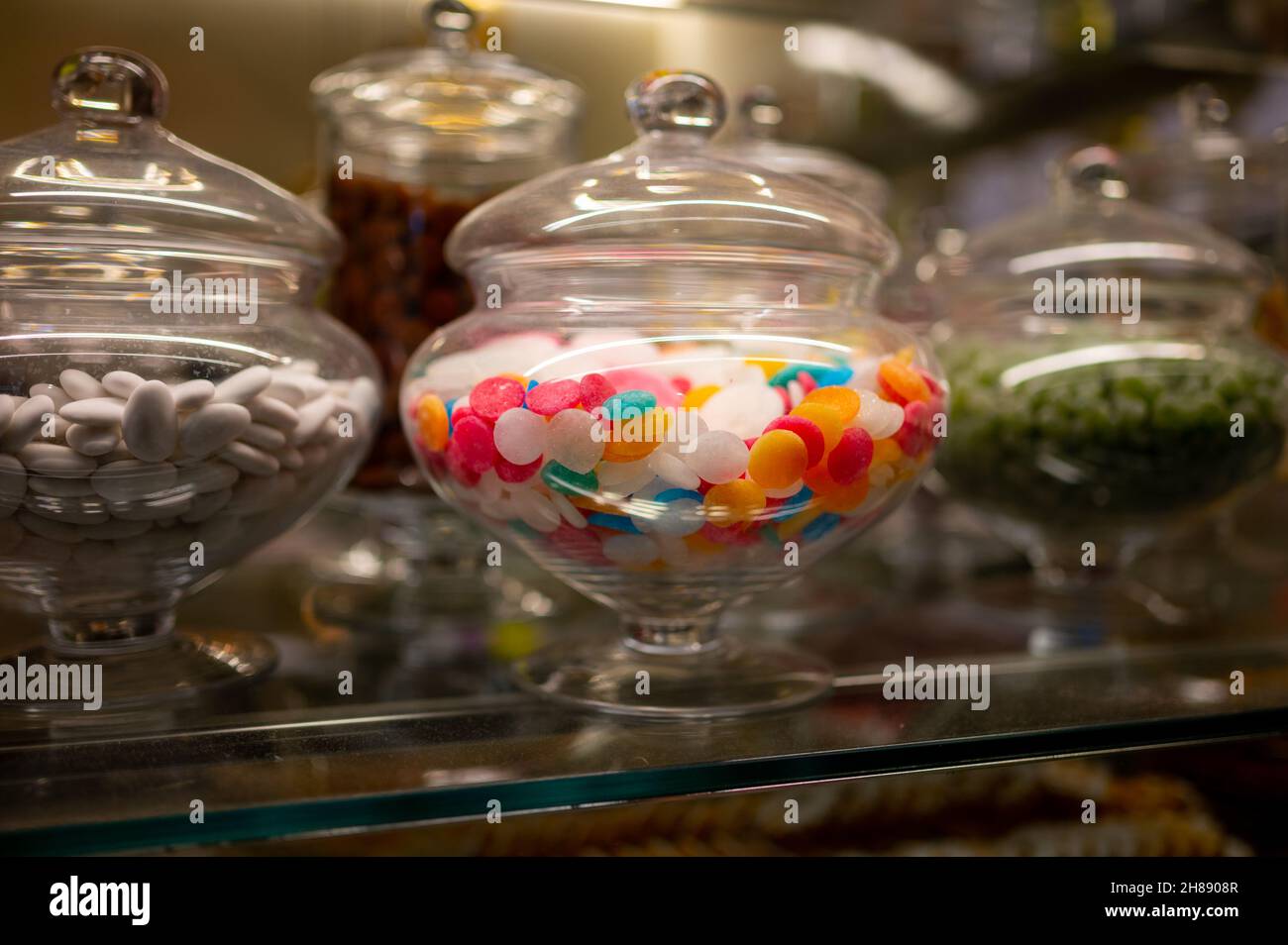Candy shop display with glass jars filled with jelly candies and bonbons close up Stock Photo ...