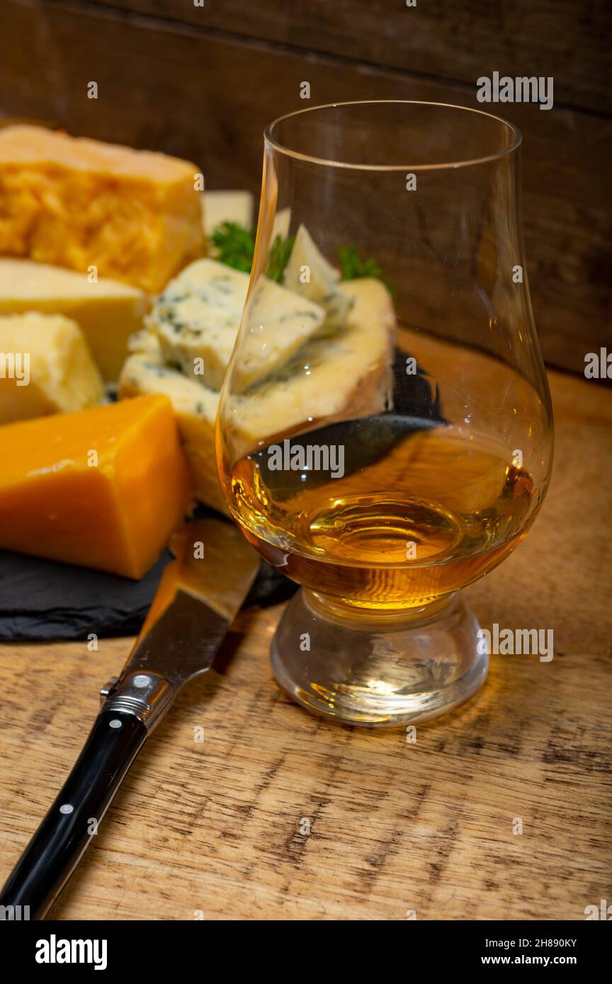 British drinks and food pairing, glasses of Scotch whisky and cheeses ...