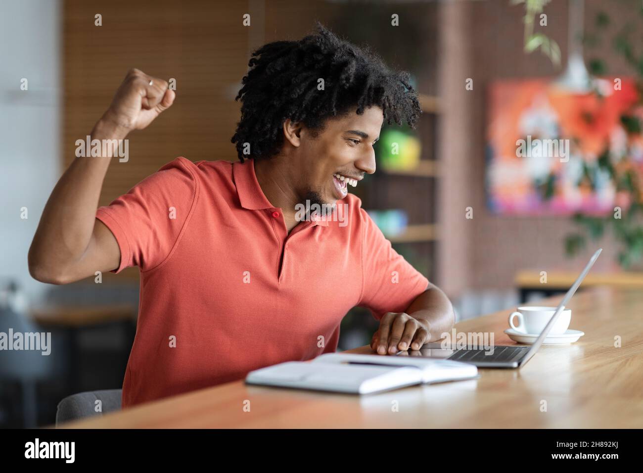 Excited successful african man reading hi-res stock photography and ...