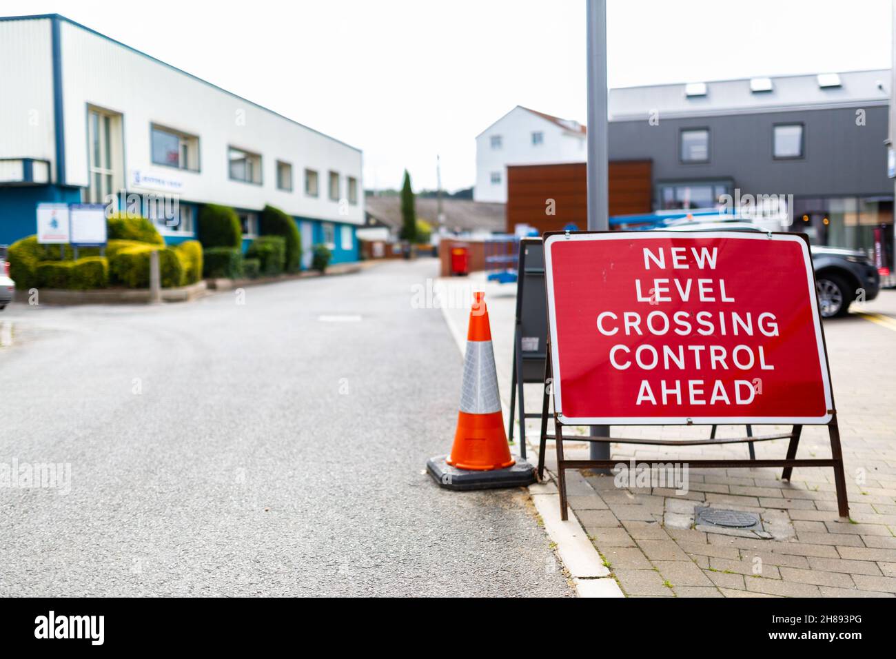 'New level crossing control ahead' sign in a town centre informing the ...