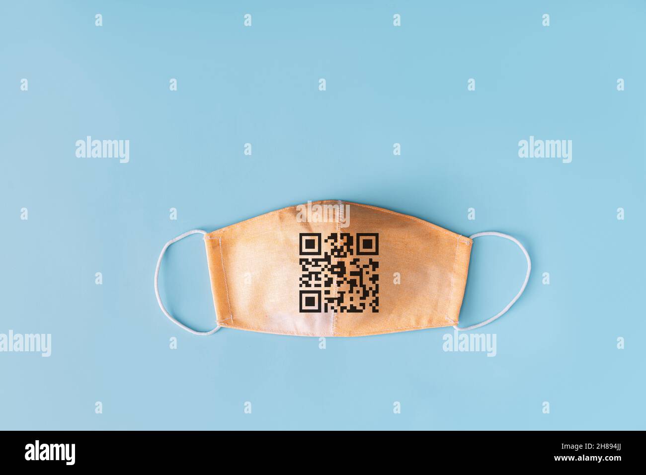 Beige safety mask with qr code on blue background Stock Photo - Alamy
