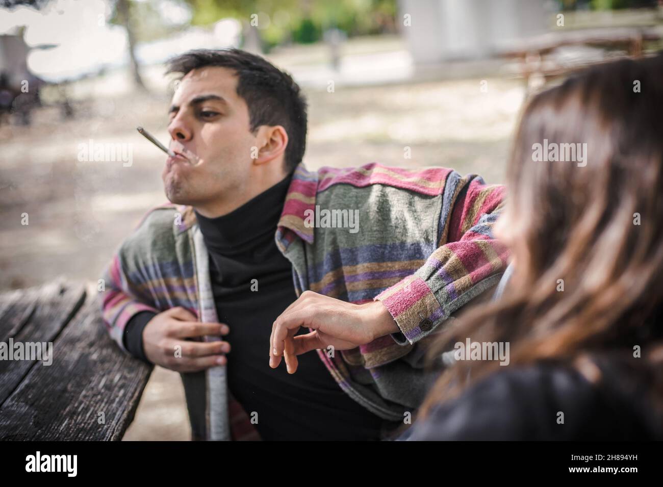 Young couple, woman and man, smoking cannabis marijuana ganja or ...