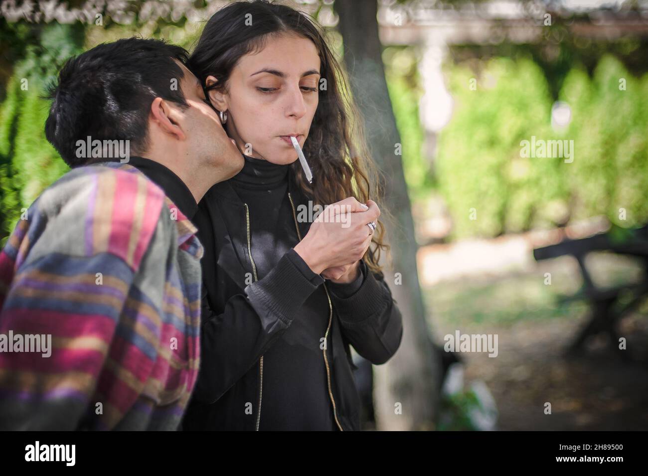 Young couple, woman and man, smoking cannabis marijuana ganja or ...